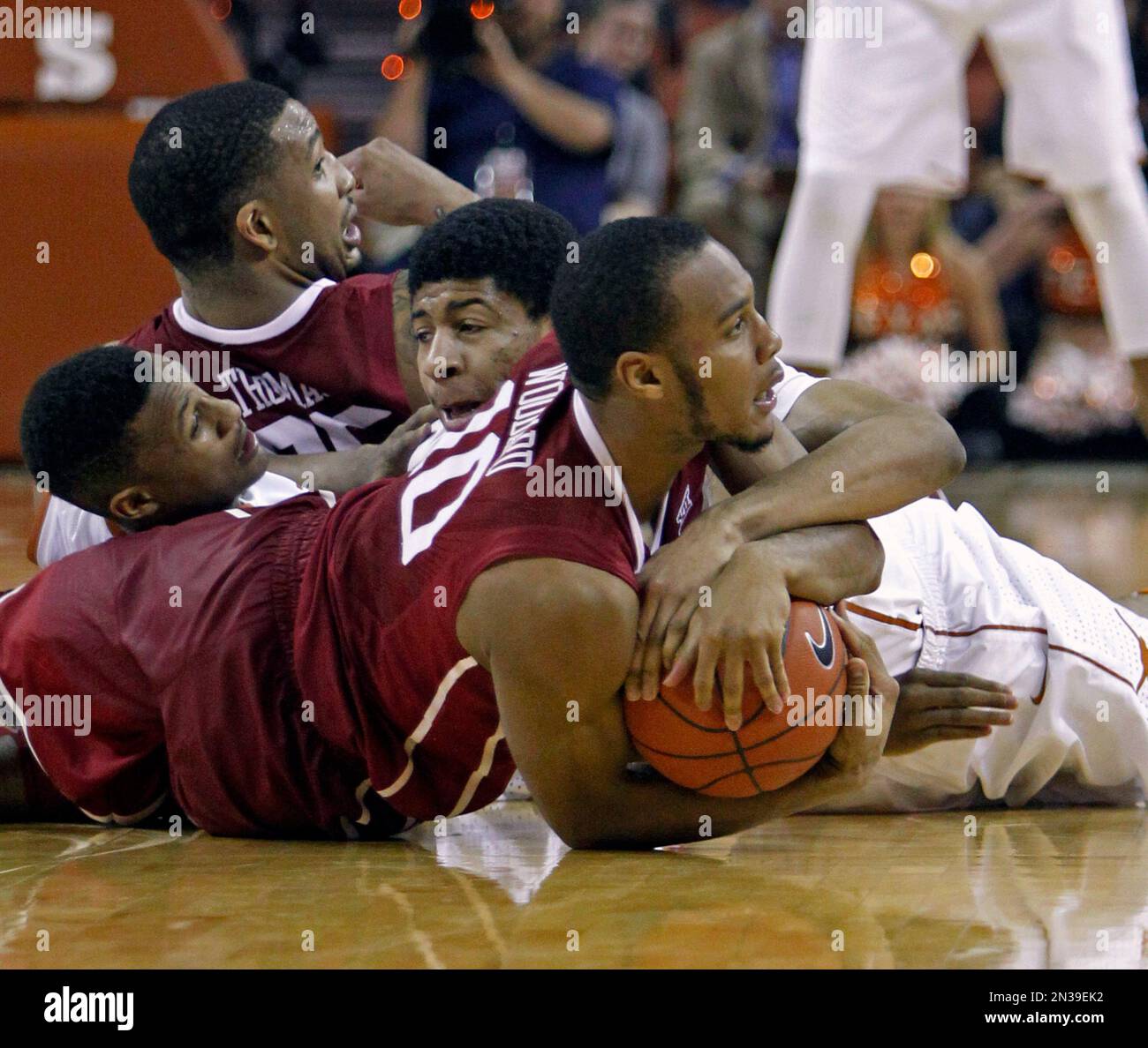 Oklahoma guard Jordan Woodard, front, is tied up by Texas forward ...