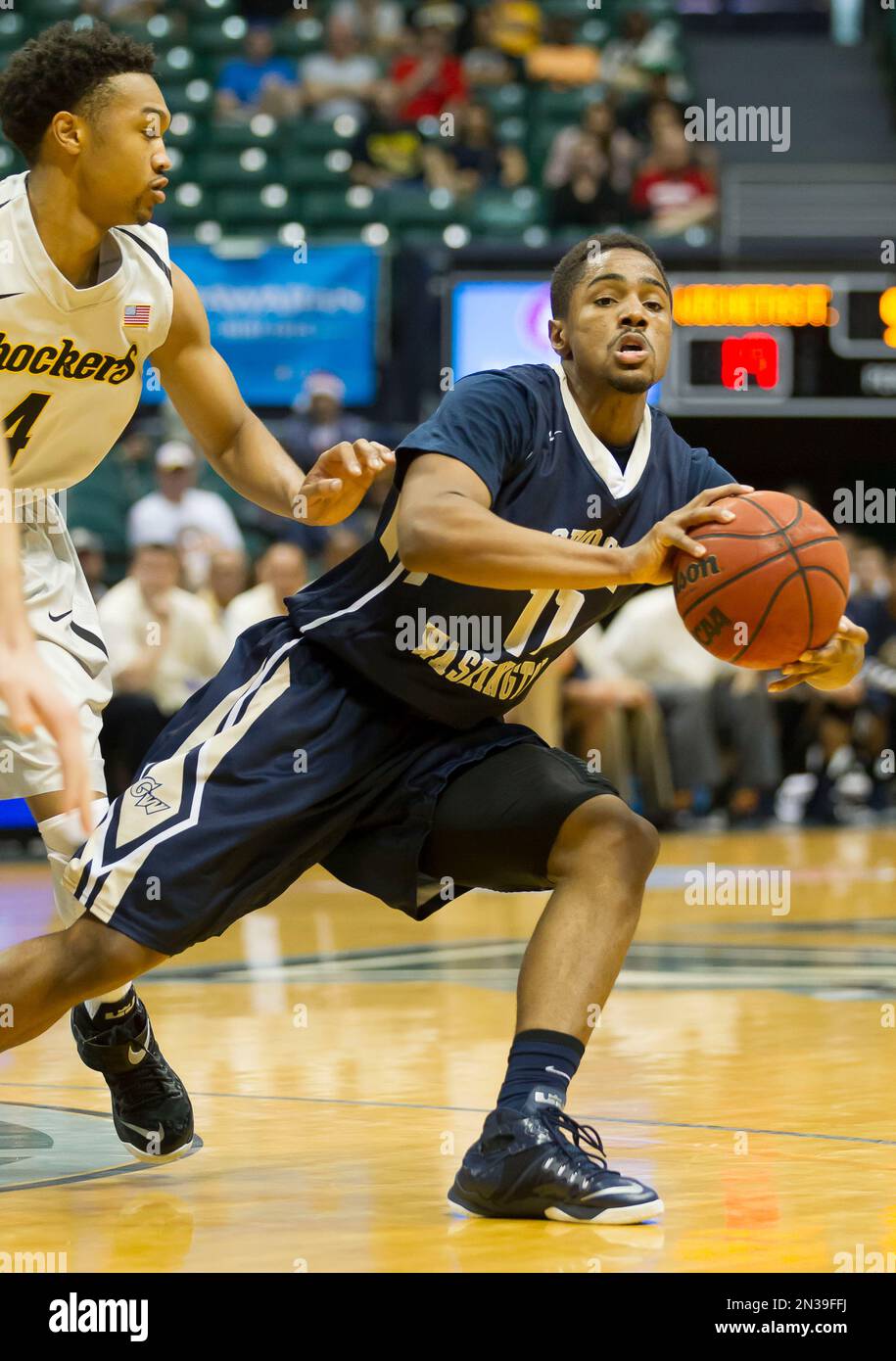 George Washington guard Kethan Savage (11) looks to pass off the ...