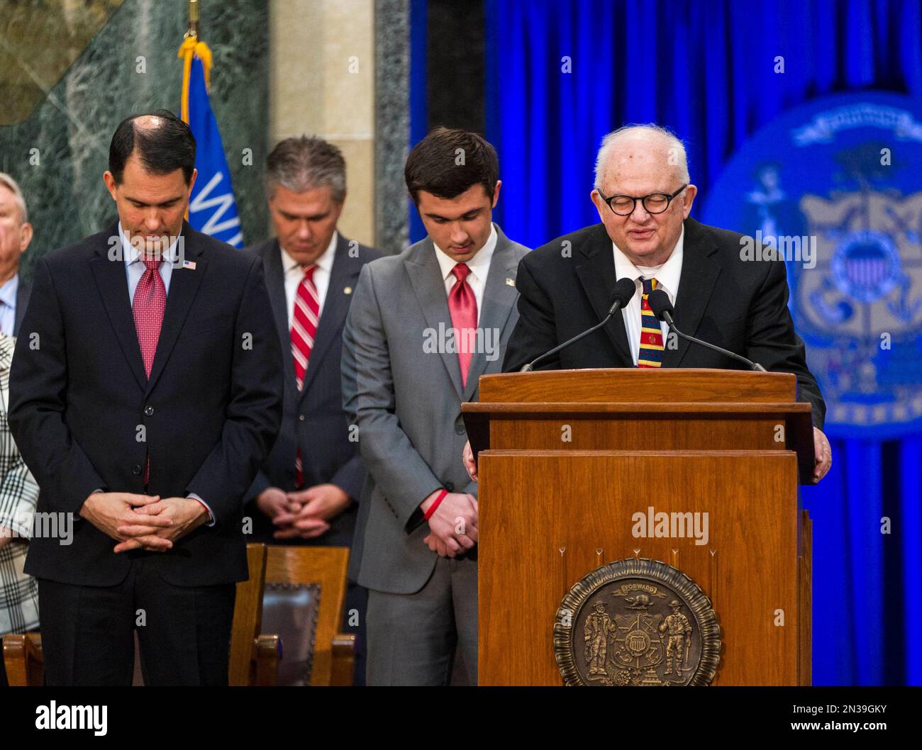 Rev. Llewellyn Scott Walker, right, gives the benediction for his son ...