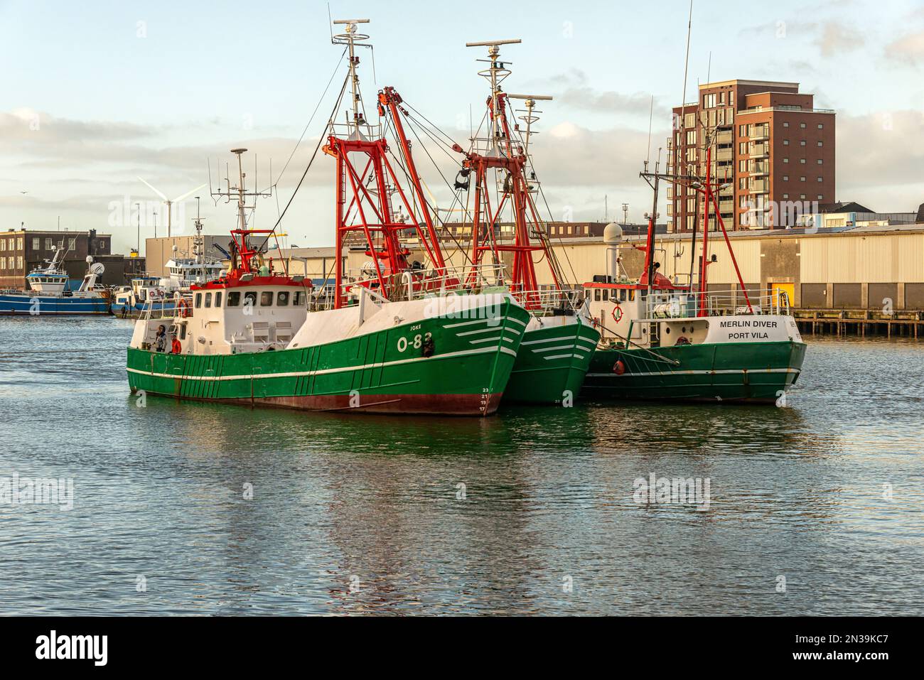 three green colored trawlers in the middle of the channel Stock Photo ...