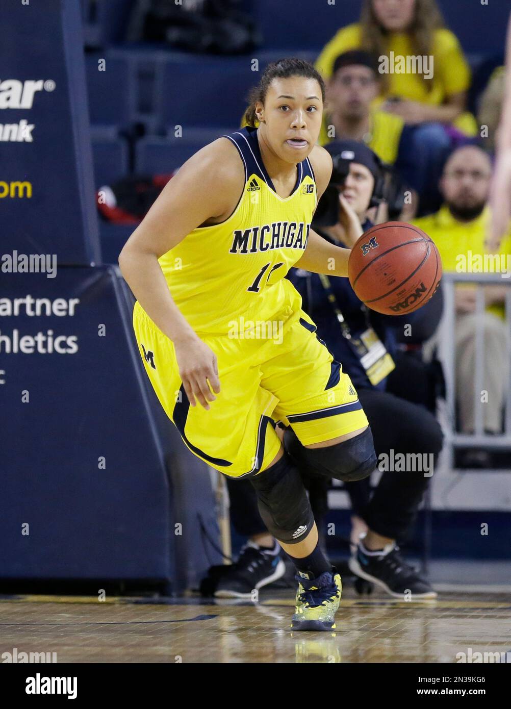 Michigan guard Jillian Dunston dribbles during the first half of an ...