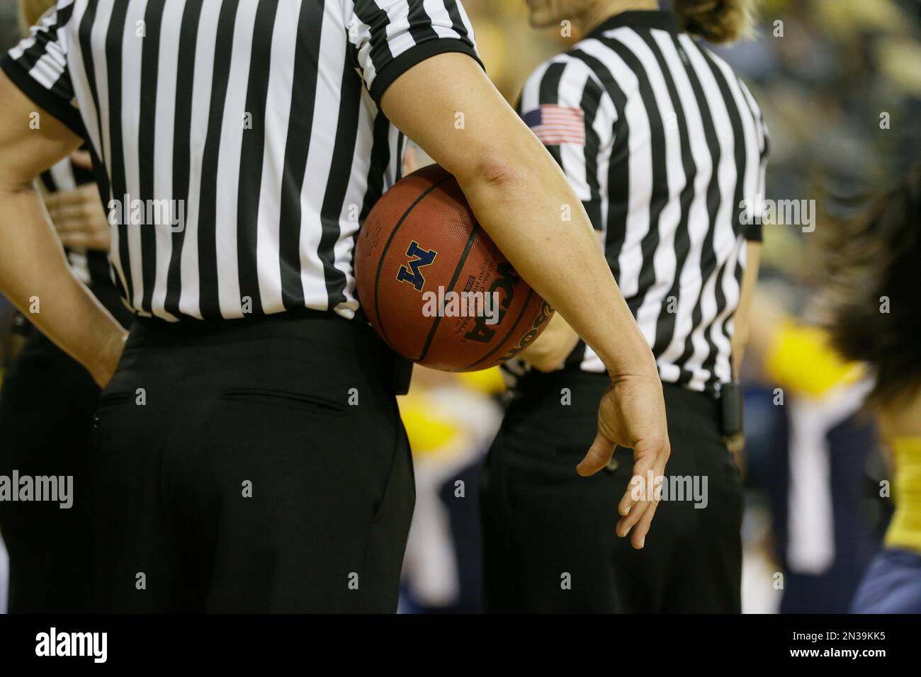 A referee holds the game ball during the second half of an NCAA college ...