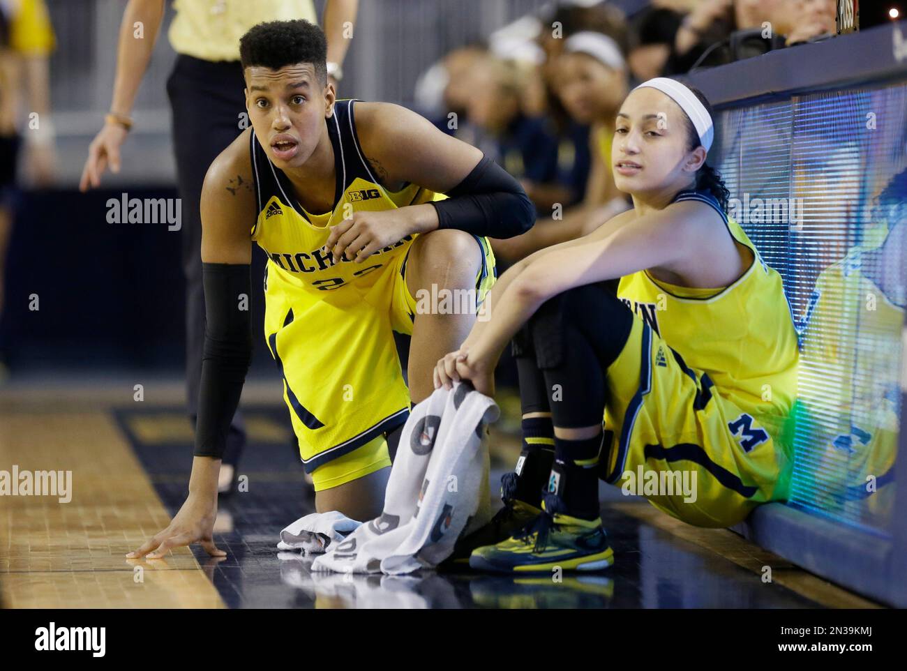 Michigan forward Cyesha Goree, left, and guard Shannon Smith wait to ...