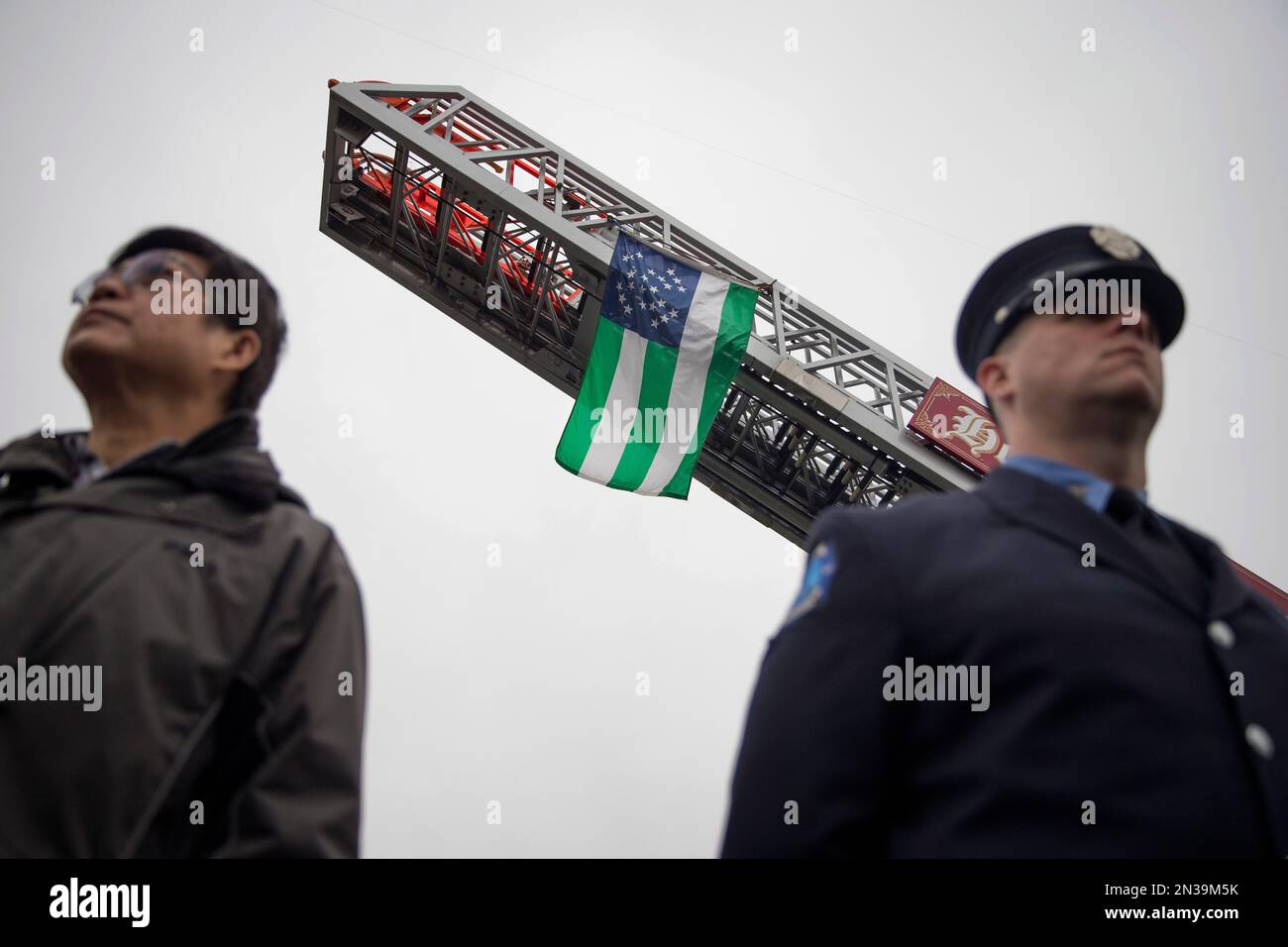A New York Police Department flag hangs from a FDNY ladder during the ...