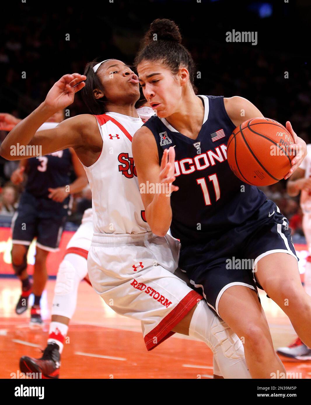 Connecticut's Kia Nurse (11) is fouled as she drives against St. John's ...