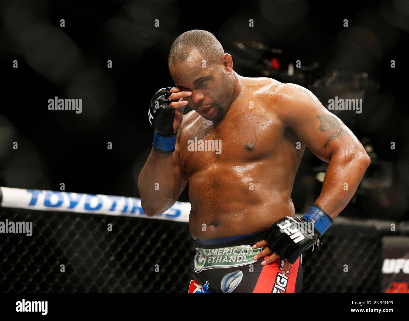 Daniel Cormier rubs his eye after he was poked in the eye by Jon Jones ...