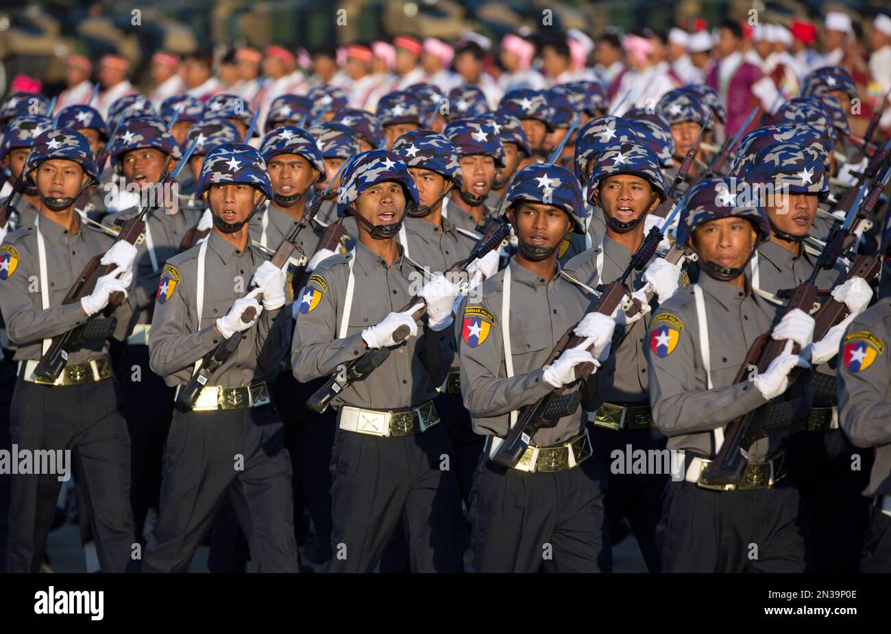 Myanmar police officers march during a ceremony to mark Myanmar's 67th ...