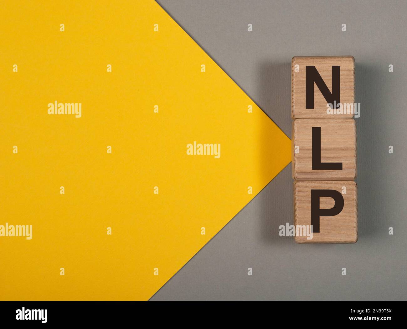 Neuro-linguistic programming, NLP acronym on wood cubes on yellow ...
