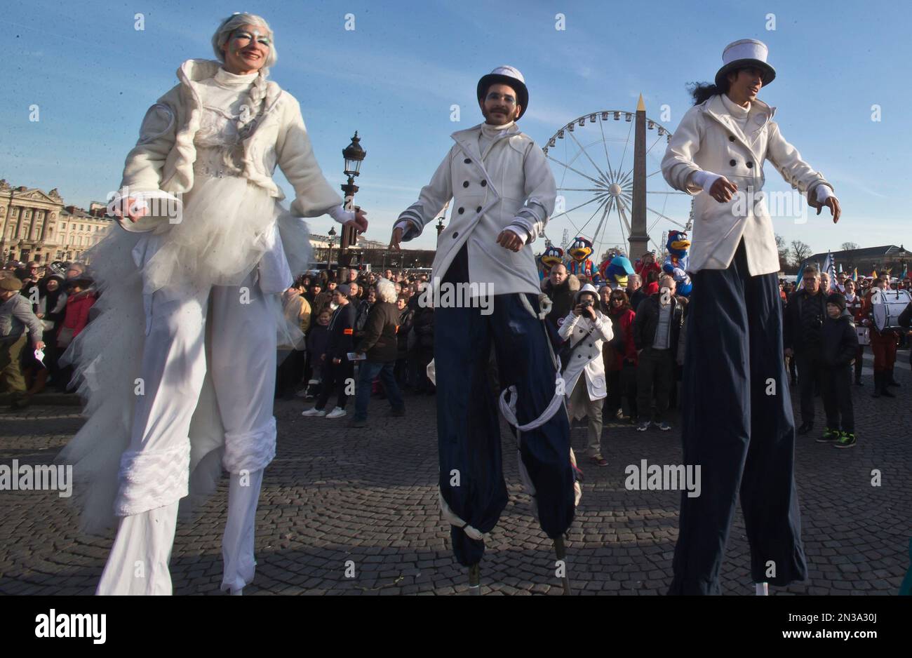 Costumed people on stilts march at the New Year's Day parade on the ...