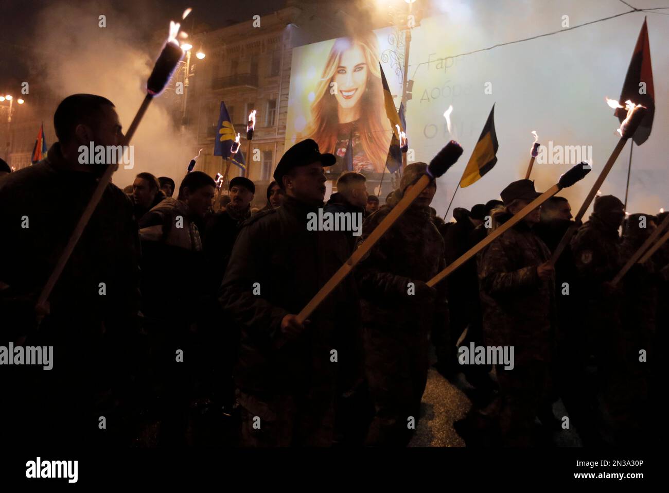 Ukrainian nationalists carry torches during a rally in downtown Kiev ...