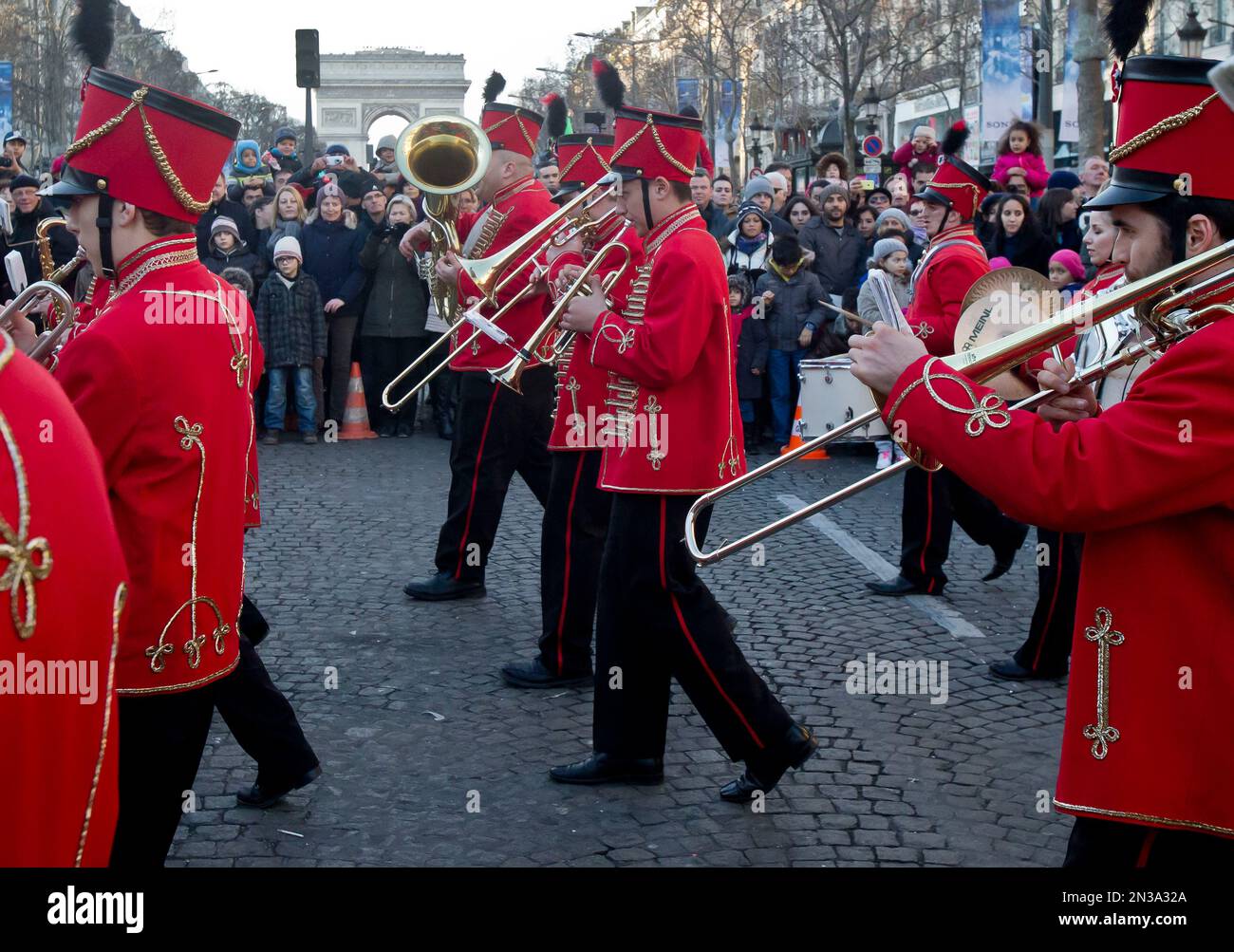 A marching band walks on the Champs-Elysee avenue during a New Year's ...