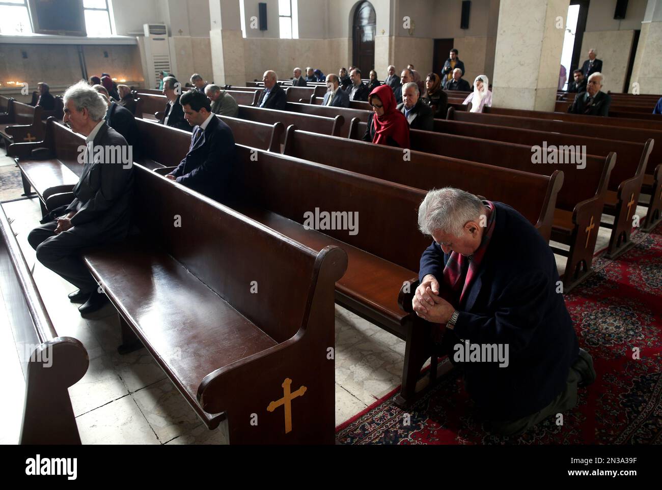 Iranian Christians pray during the New Year's mass at the saint Sarkis ...