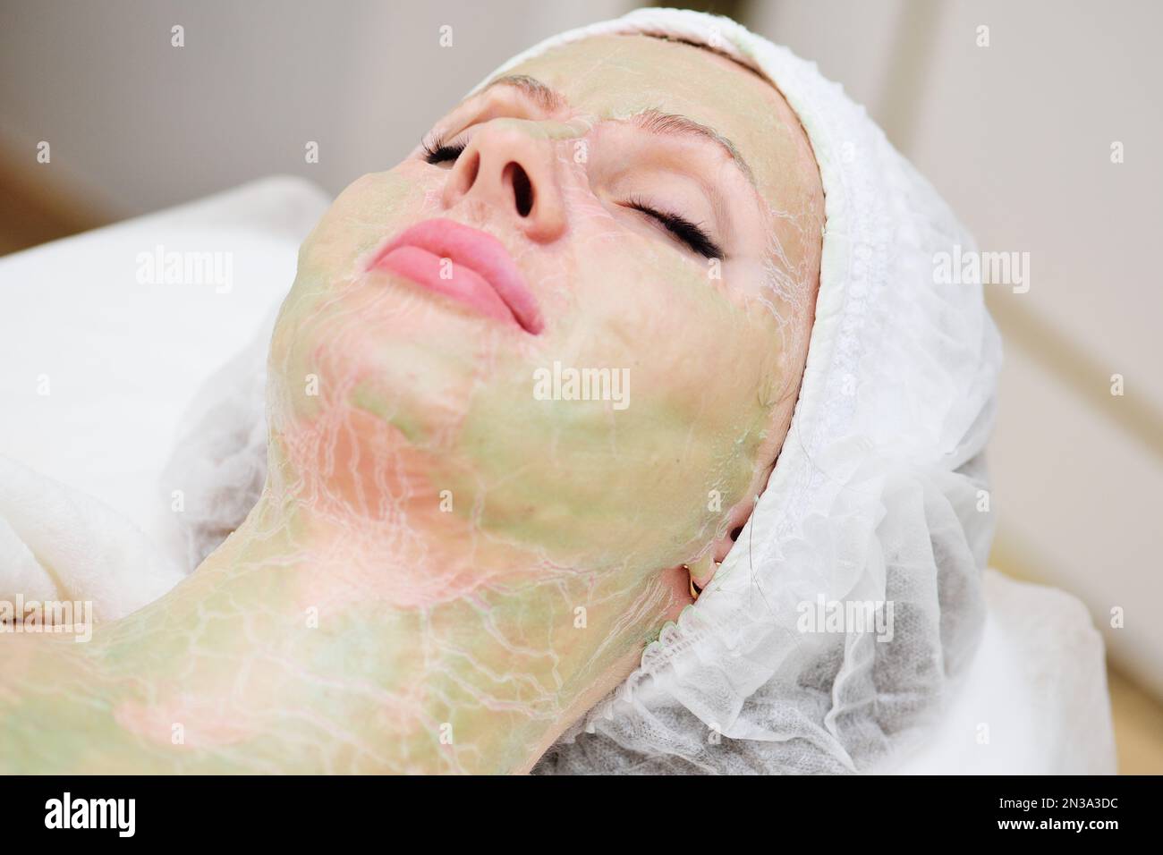 A cosmetologist performs an enzyme therapy procedure for a female ...
