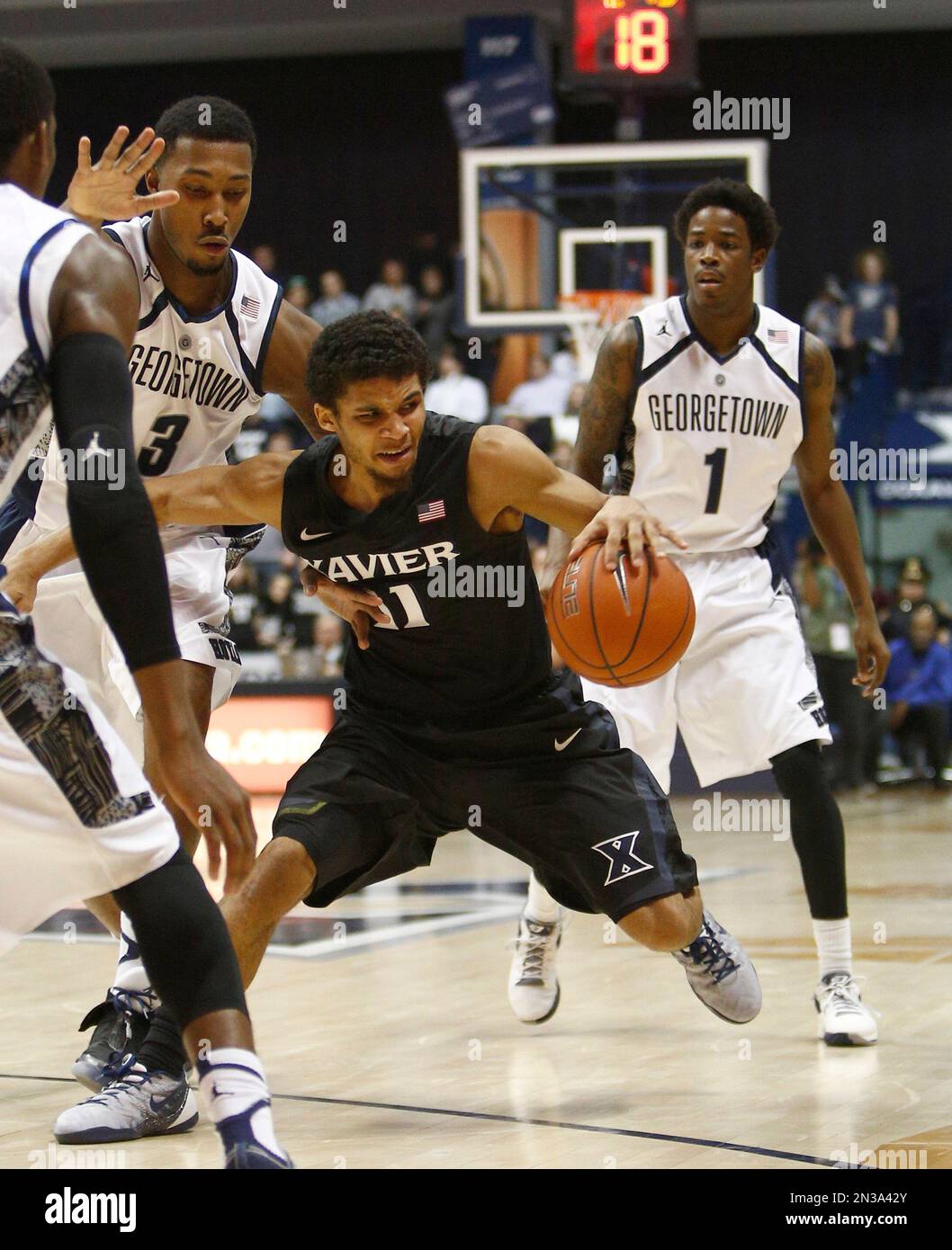 Xavier guard Dee Davis (11) drives against Georgetown forward Mikael ...
