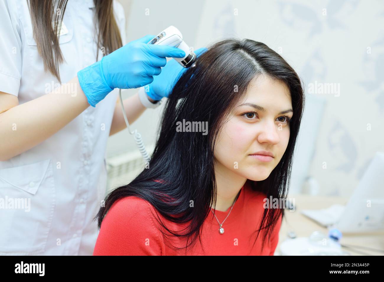 doctor cosmetologist dermatologist diagnoses the condition of the ...