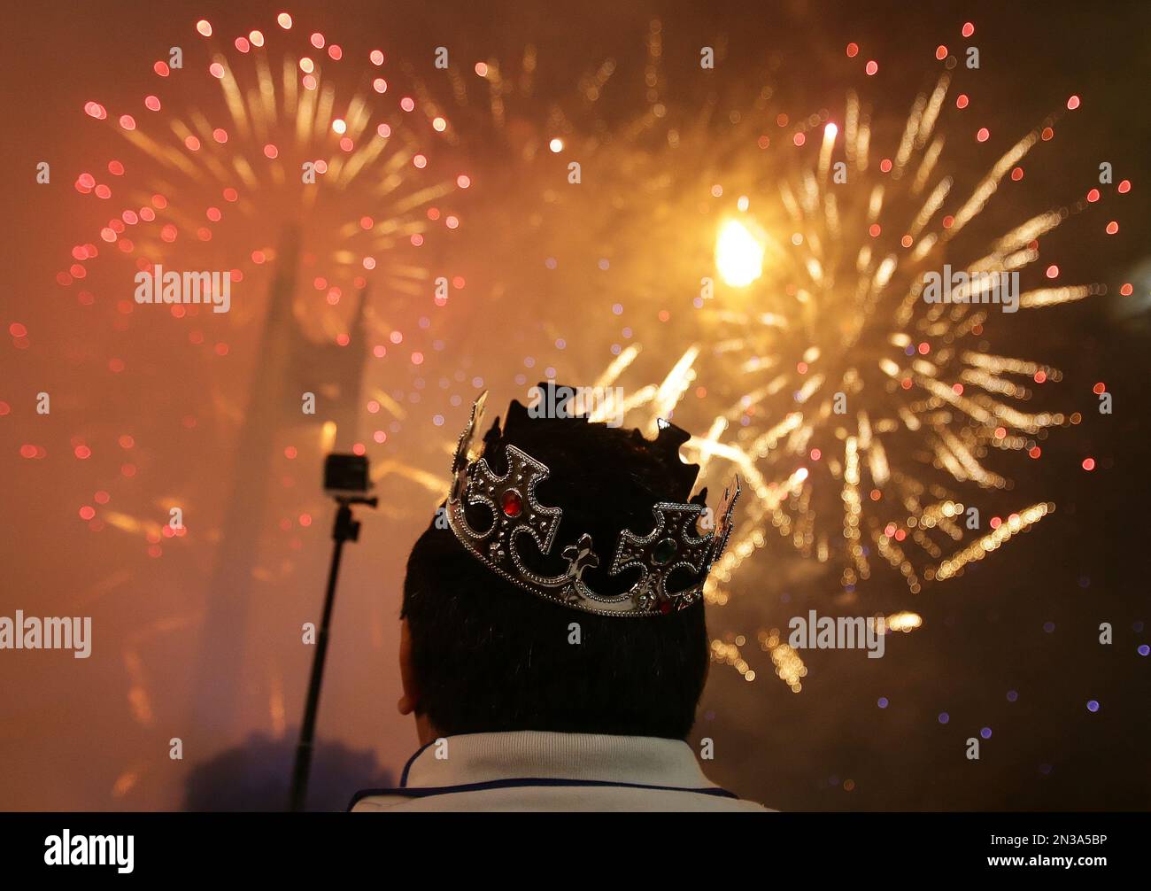 A Filipino watches a fireworks display at the Quezon Memorial Circle in ...