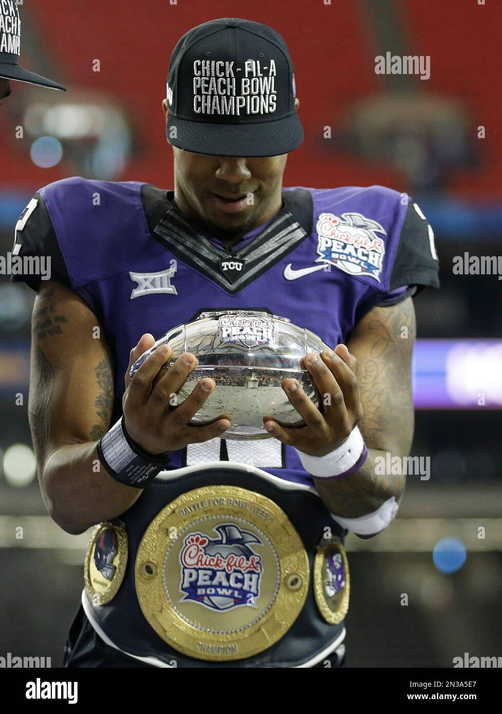 TCU quarterback Trevone Boykin holds part of the Peach Bowl Tropy after ...