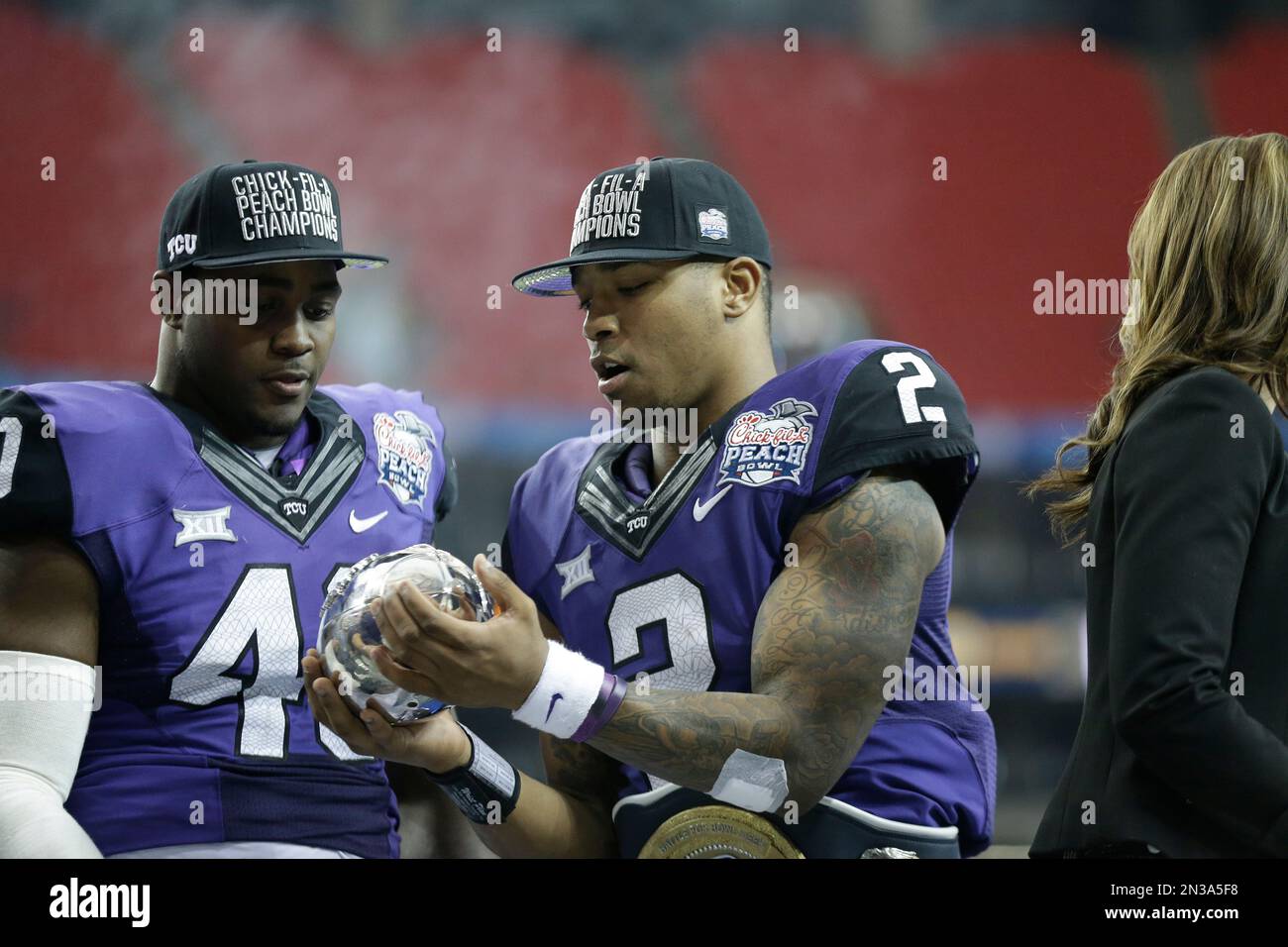 TCU quarterback Trevone Boykin holds part of the Peach Bowl Tropy after ...