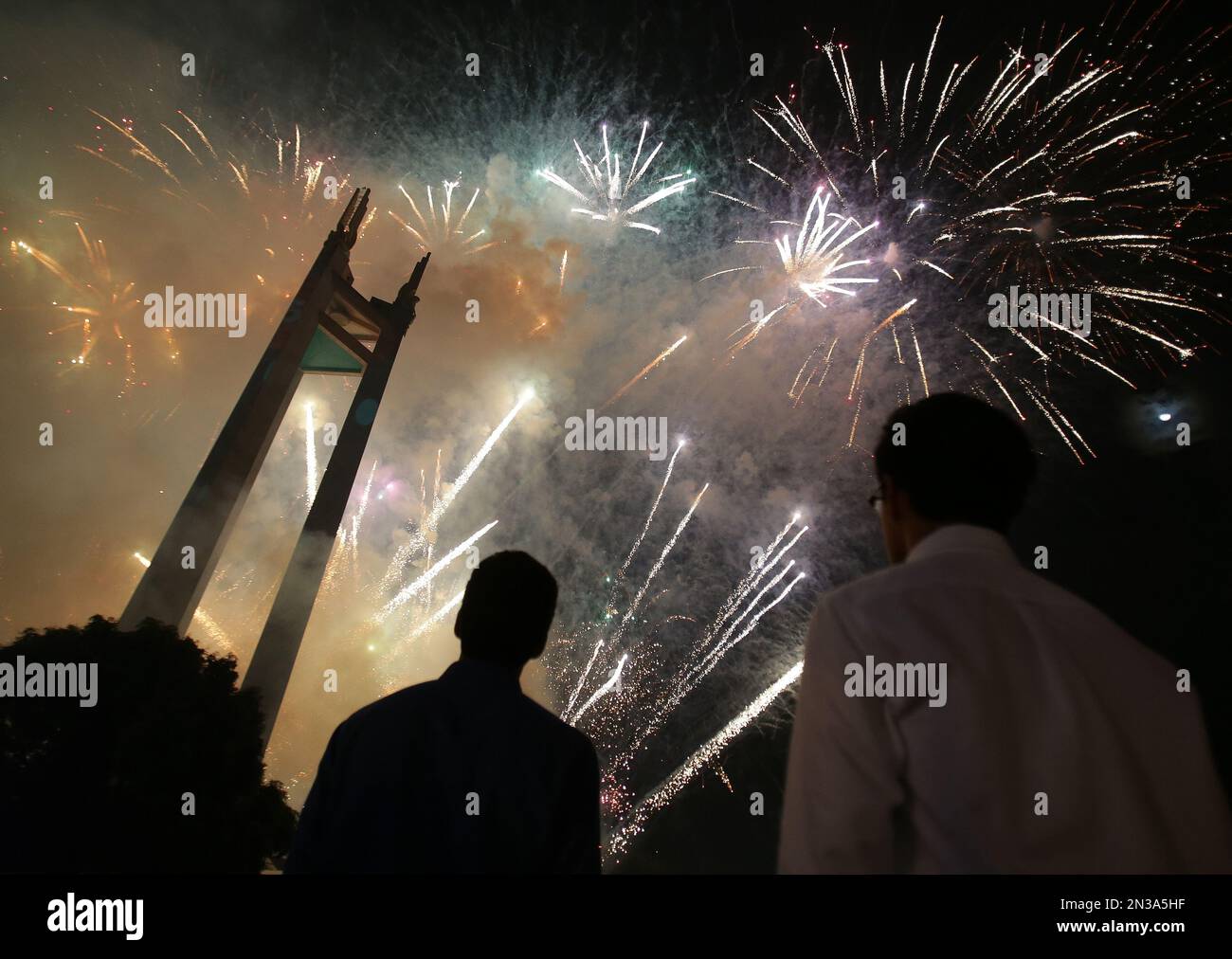 Filipino spectators watch a fireworks display during a New Year's ...