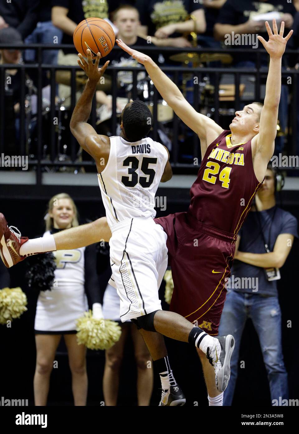 Minnesota forward Joey King (24) blocks the shot ofPurdue guard Rapheal ...