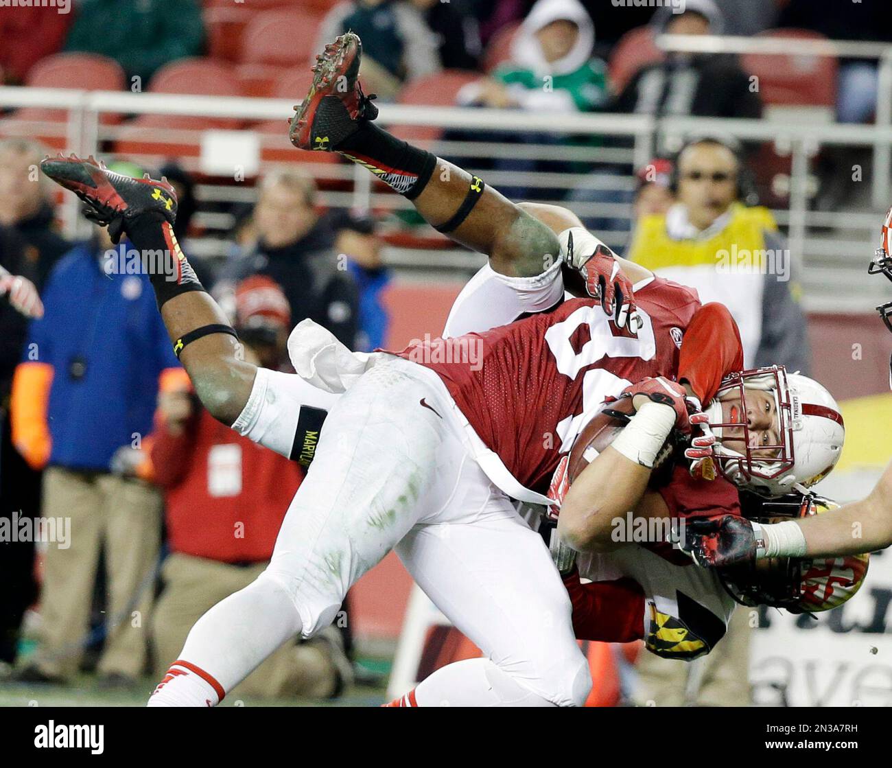 Stanford tight end Austin Hooper (84) is wrapped up by a Maryland ...