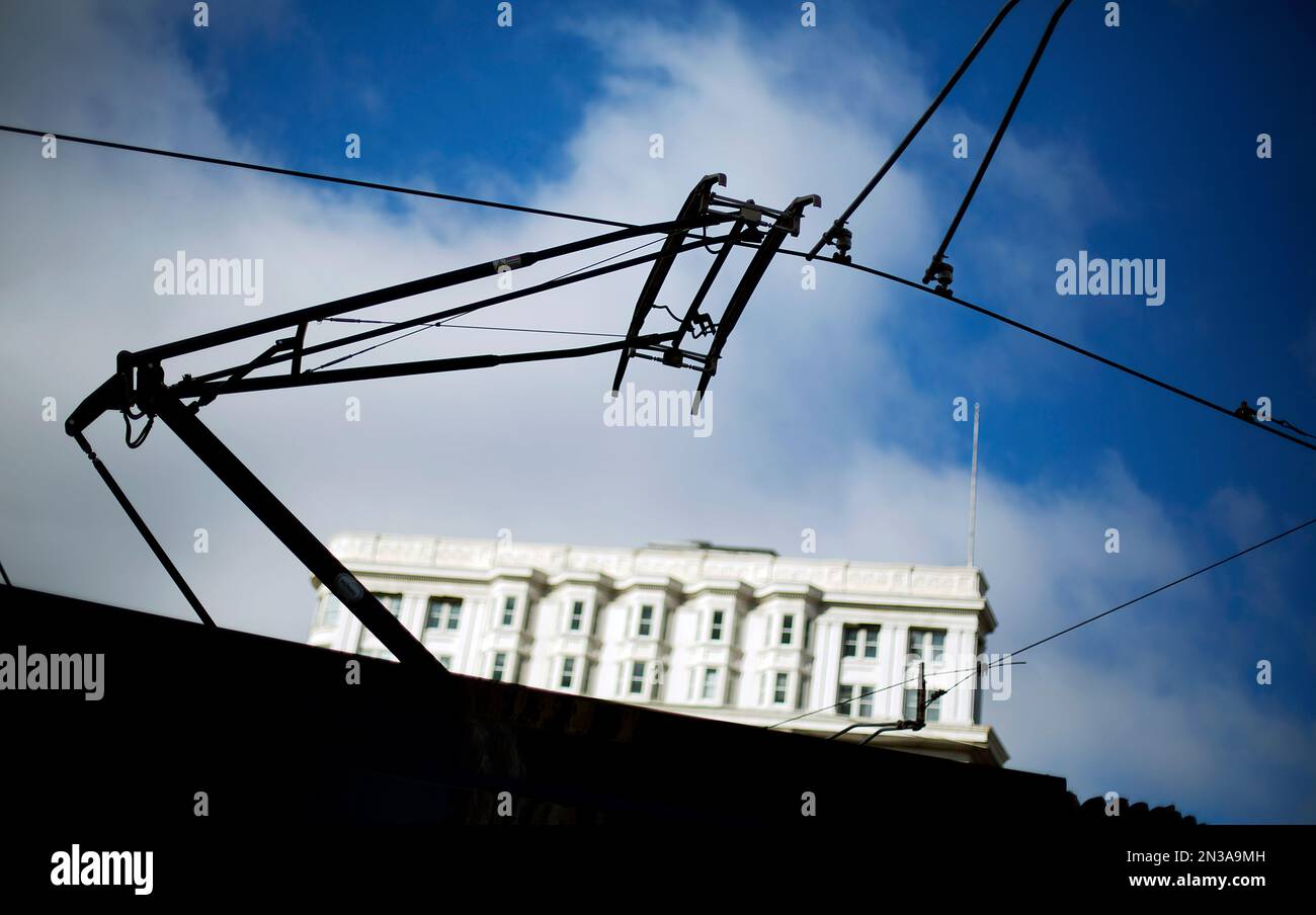 Electric cables pass through the downtown sky as an Atlanta Streetcar ...
