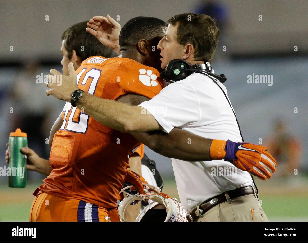 Clemson head coach Dabo Swinney, right, hugs linebacker Stephone ...