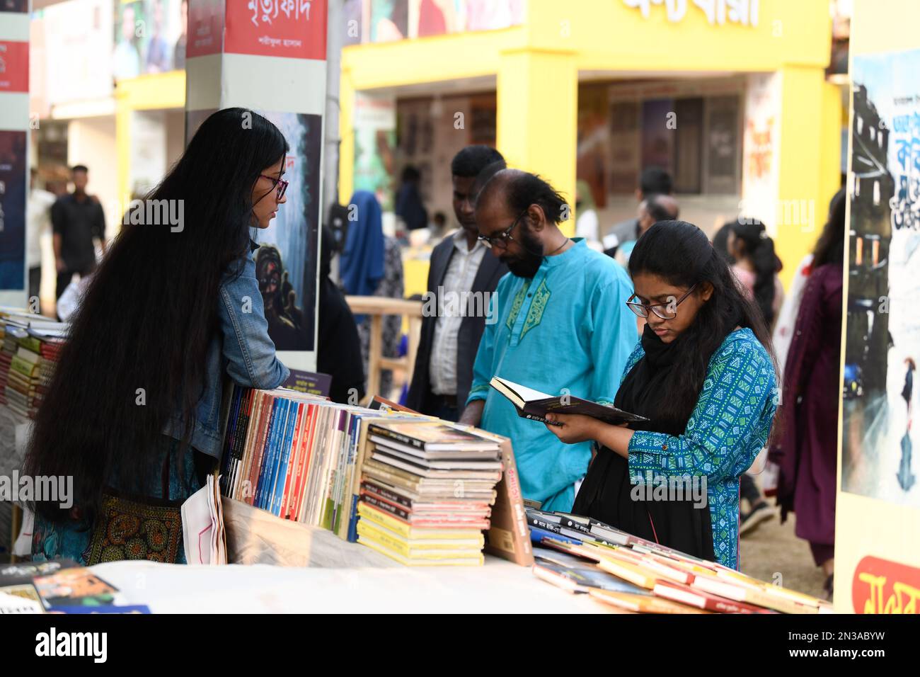 Dhaka, Bangladesh. 07th Feb, 2023. Visitors read books at the national book fair named Ekushey ...