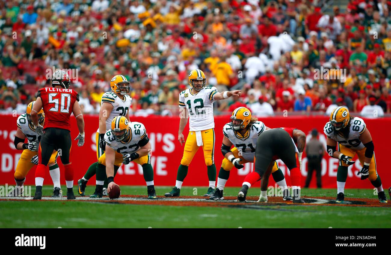 Green Bay Packers quarterback Aaron Rodgers (12) uses hand signals ...