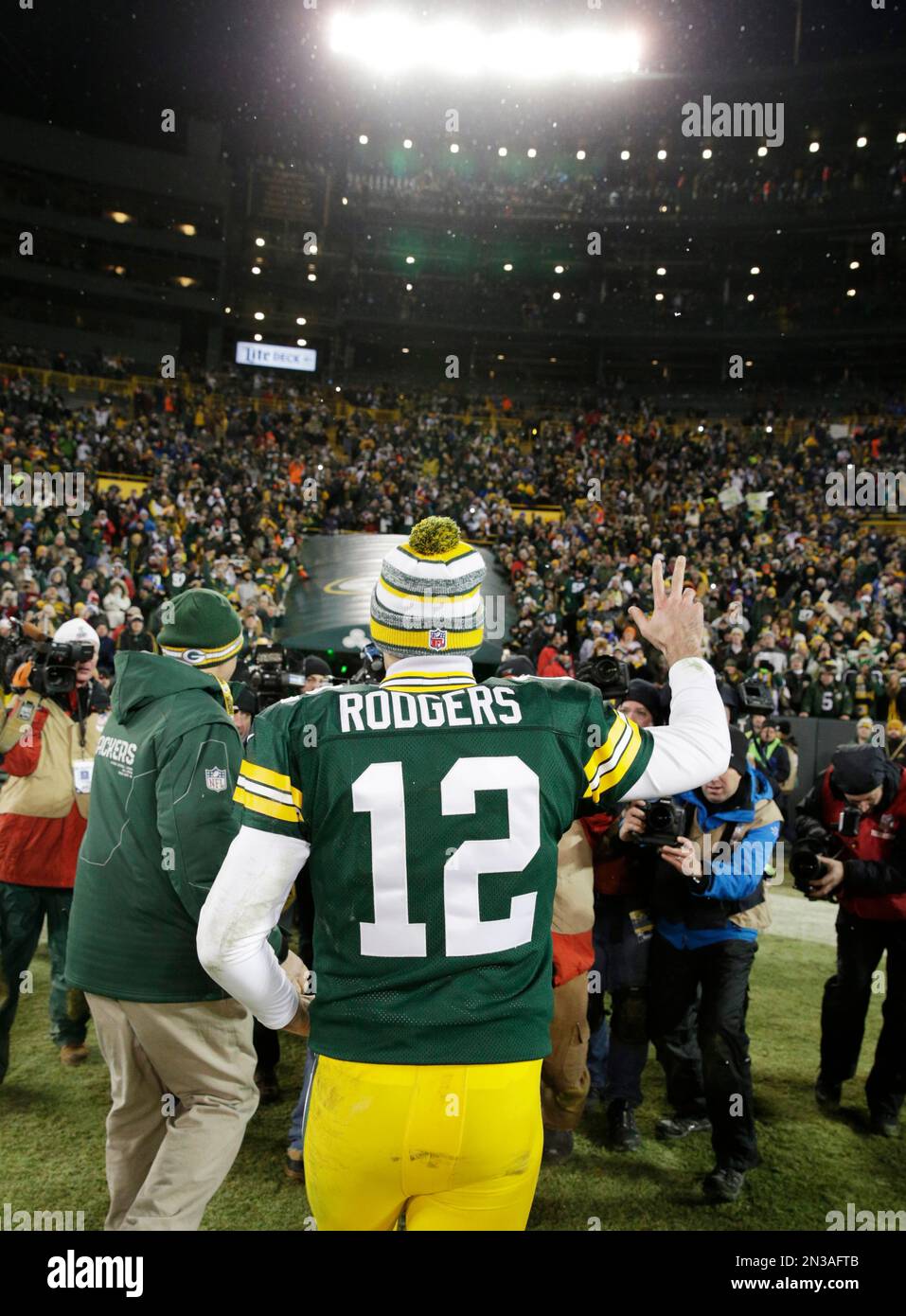 Green Bay Packers' Aaron Rodgers waves to the crowd as he leaves the ...