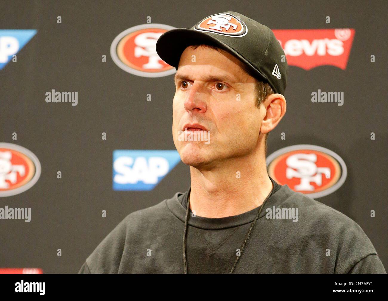 San Francisco 49ers head coach Jim Harbaugh speaks at a news conference ...