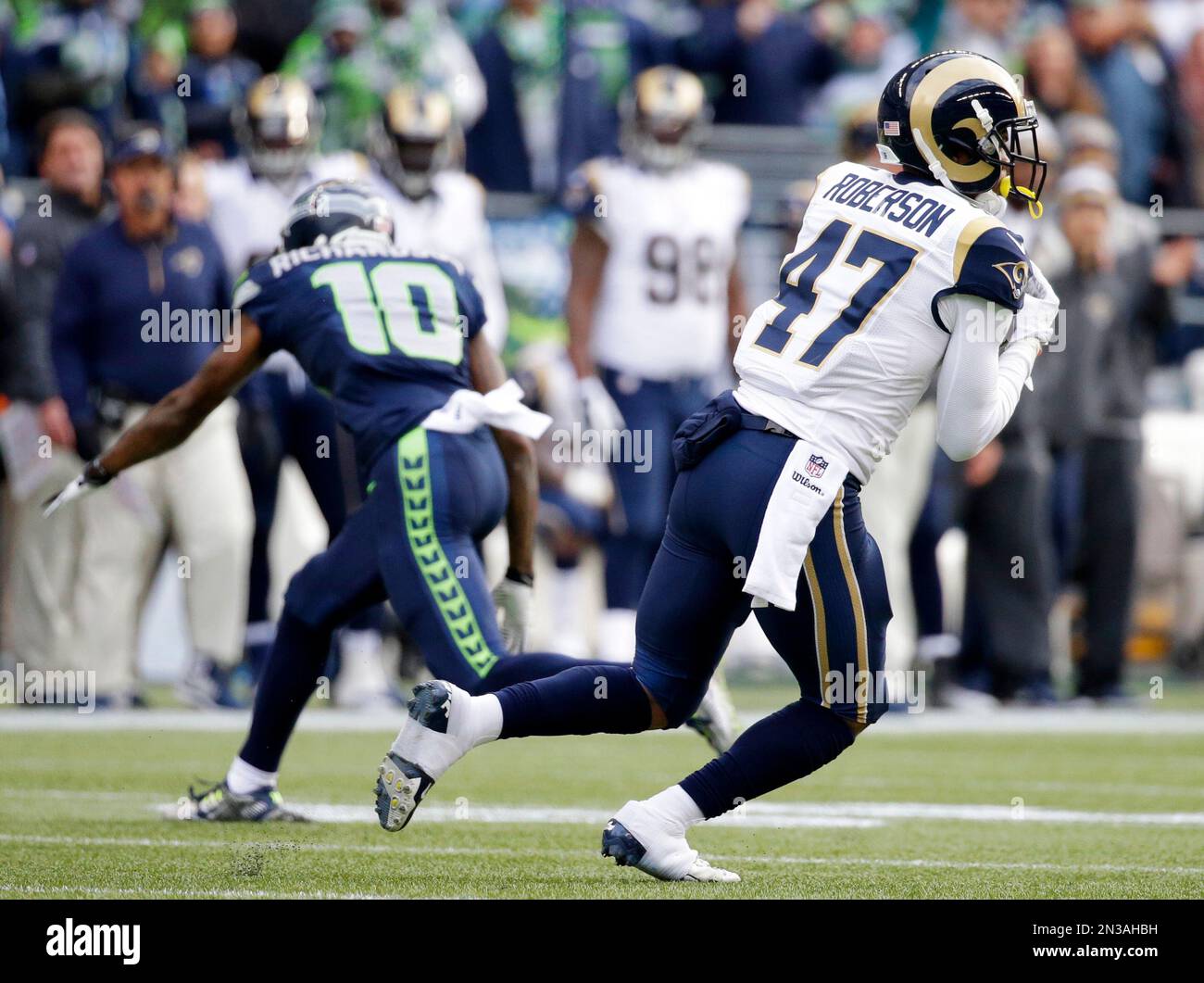 St. Louis Rams cornerback Marcus Roberson, right, runs after ...