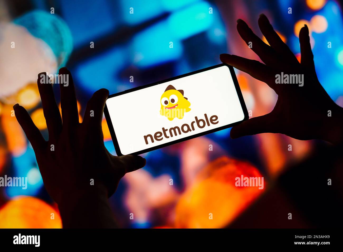 In this photo illustration, the Netmarble logo is displayed on a smartphone screen Stock Photo ...
