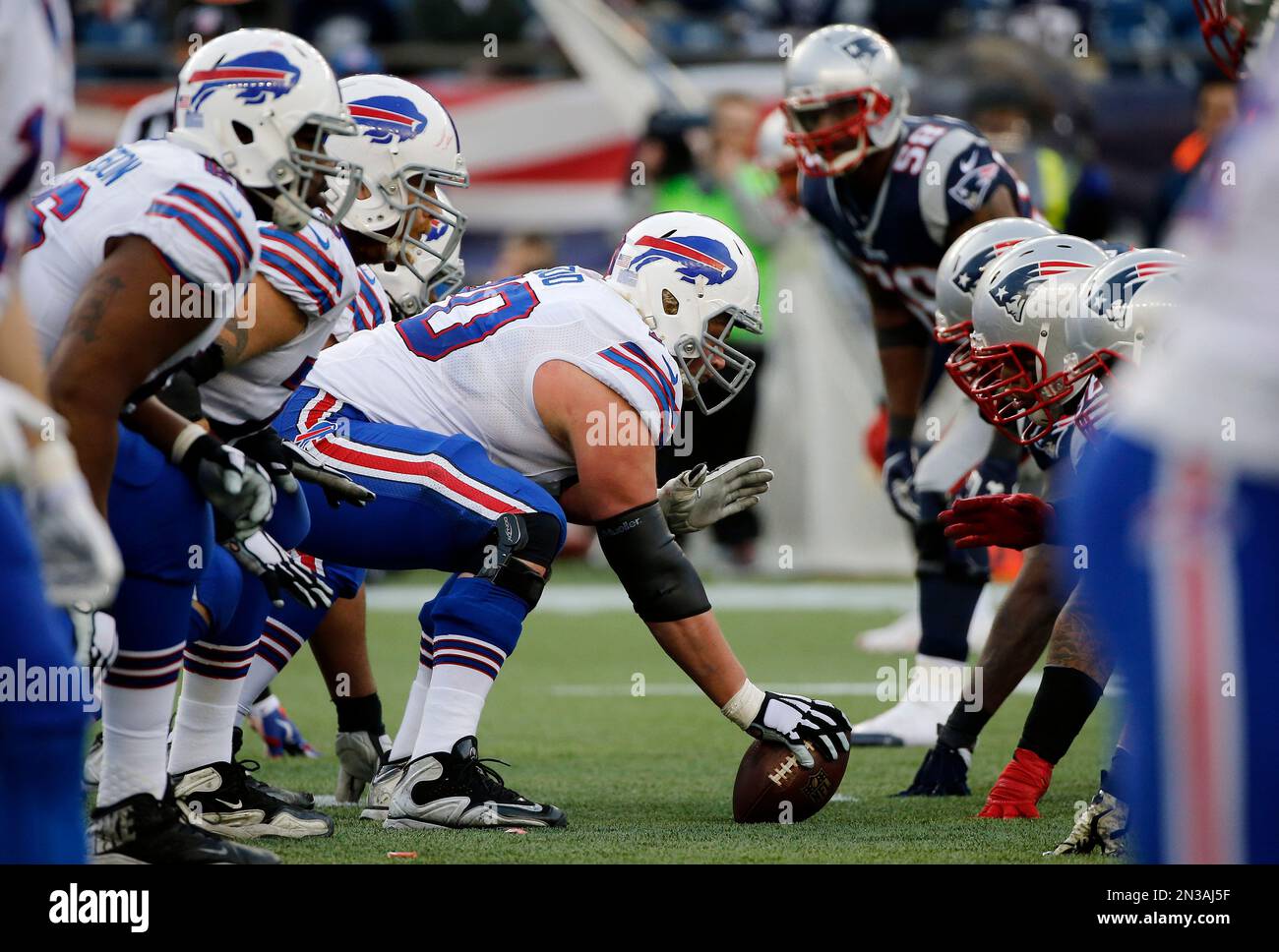 The Buffalo Bills and the New England Patriots face off at the line of ...