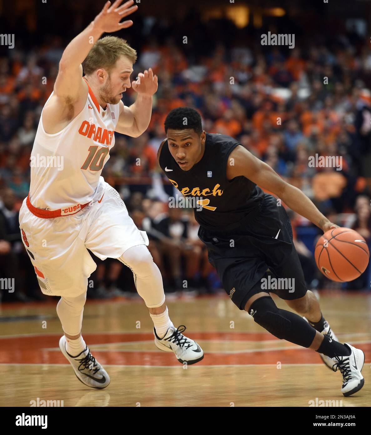 Long Beach State's Mike Caffey, right, drives against Syracuse's Trevor ...
