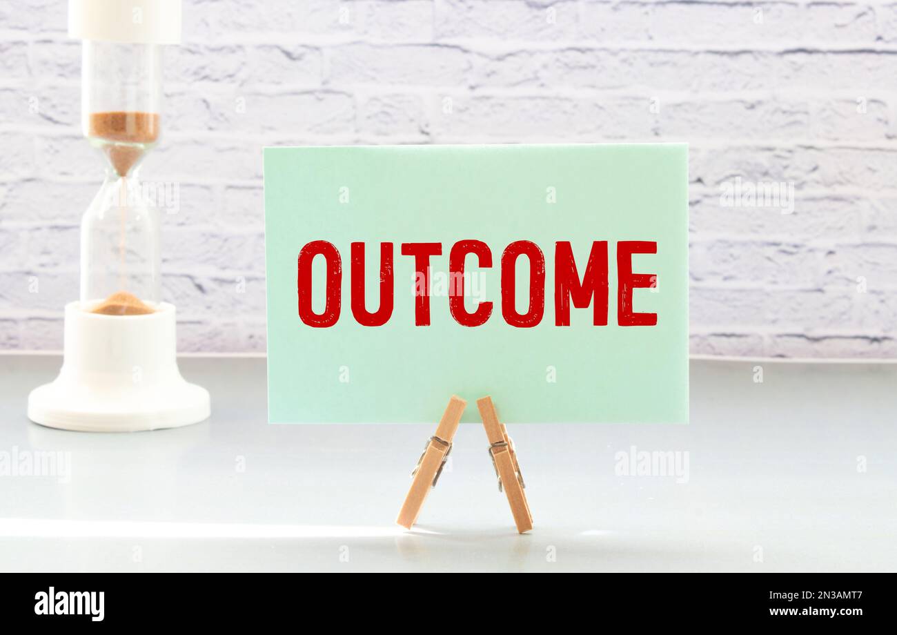 Black color letter in word outcome on white felt board background Stock ...