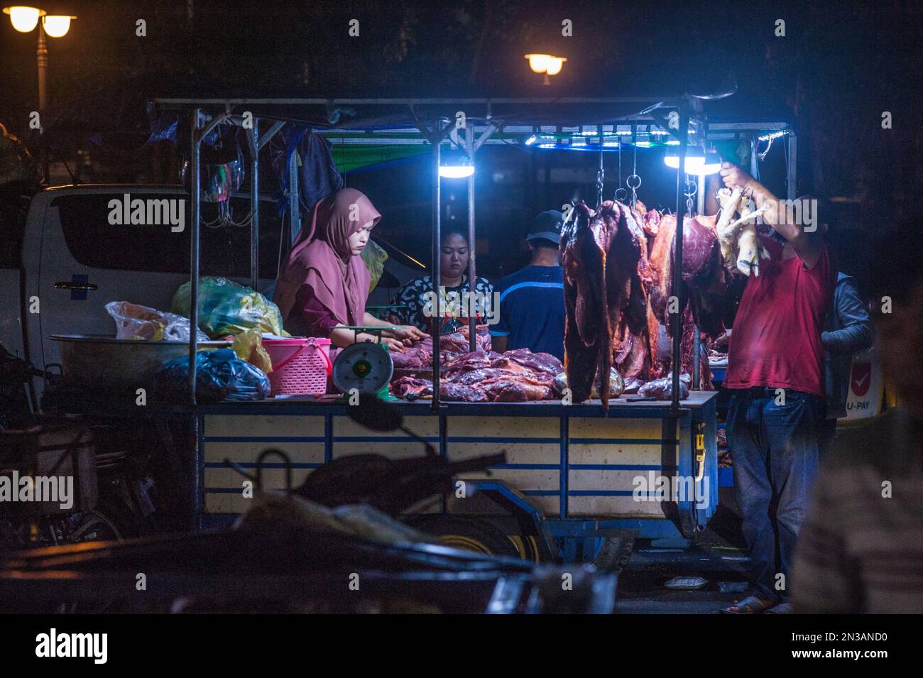 A Muslim woman selling raw meat at the main wholesale vegetable & meat ...