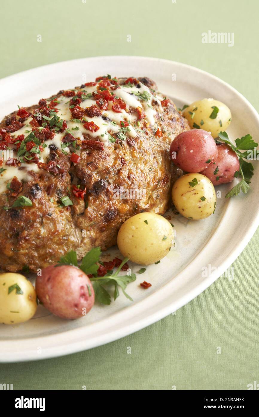 Slow cooked meatloaf topped with sundried tomatoes and served with ...