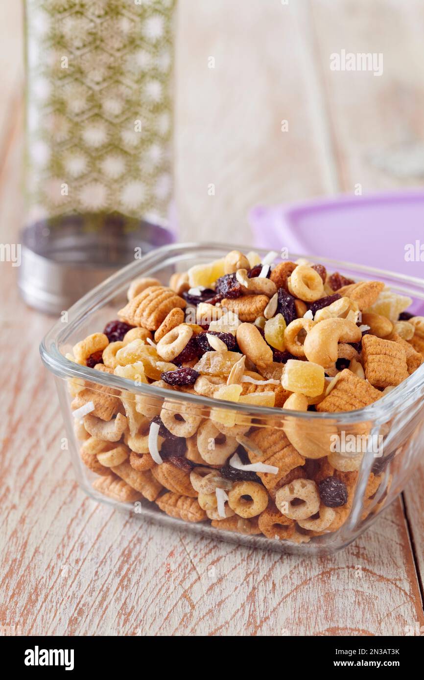 Healthy snack mix in a portable glass storage container with a water ...