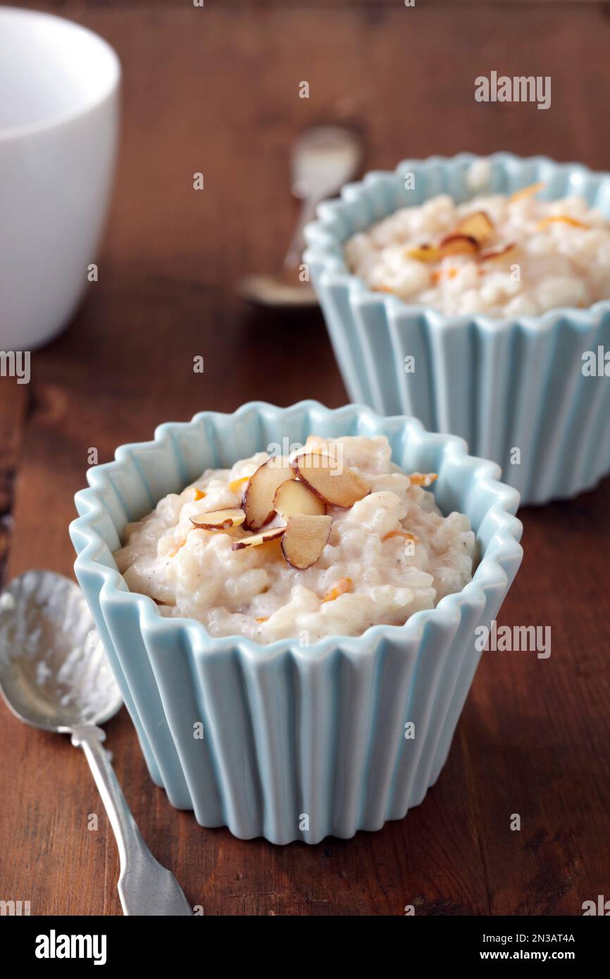 Rice pudding with sliced almonds in small blue bowls Stock Photo - Alamy