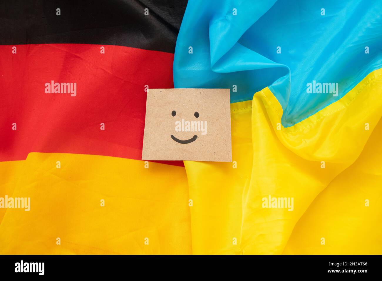 Flags of Ukraine and Germany, and between them a card with a smiley ...