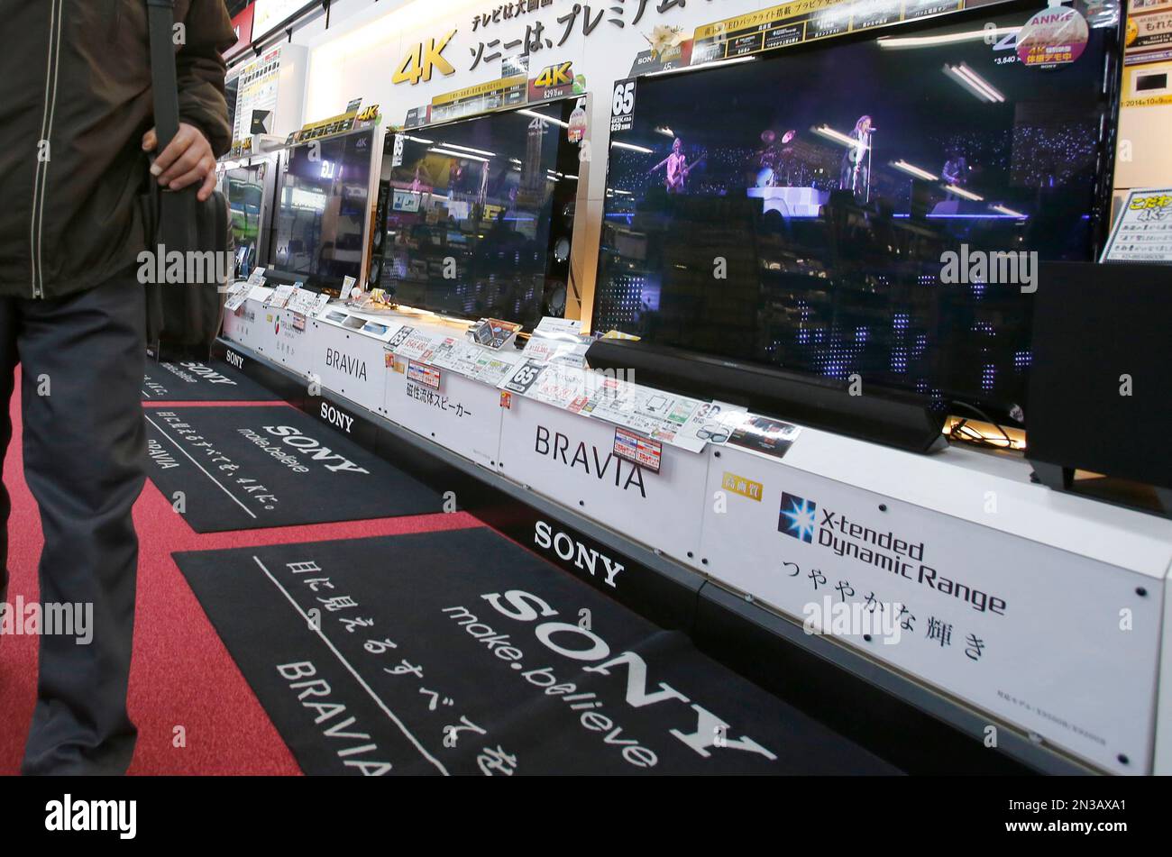 In this Thursday, Dec. 25, 2014 photo, a shopper walks by Sony's Bravia ...