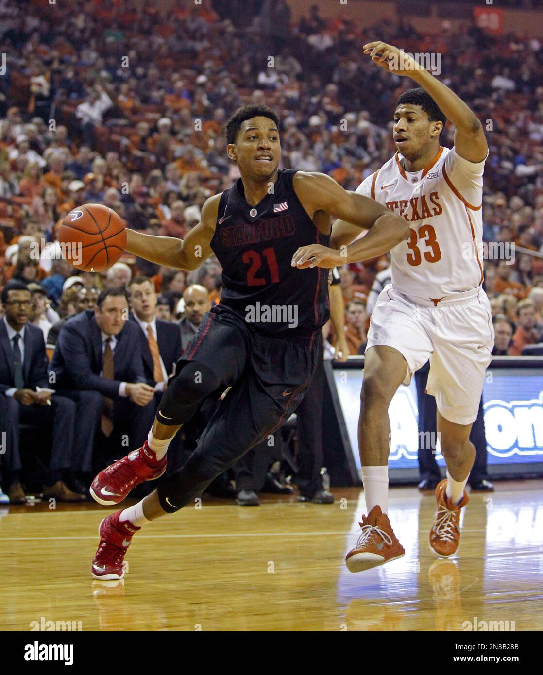Stanford guard Anthony Brown (21) drives around Texas forward Jordan ...