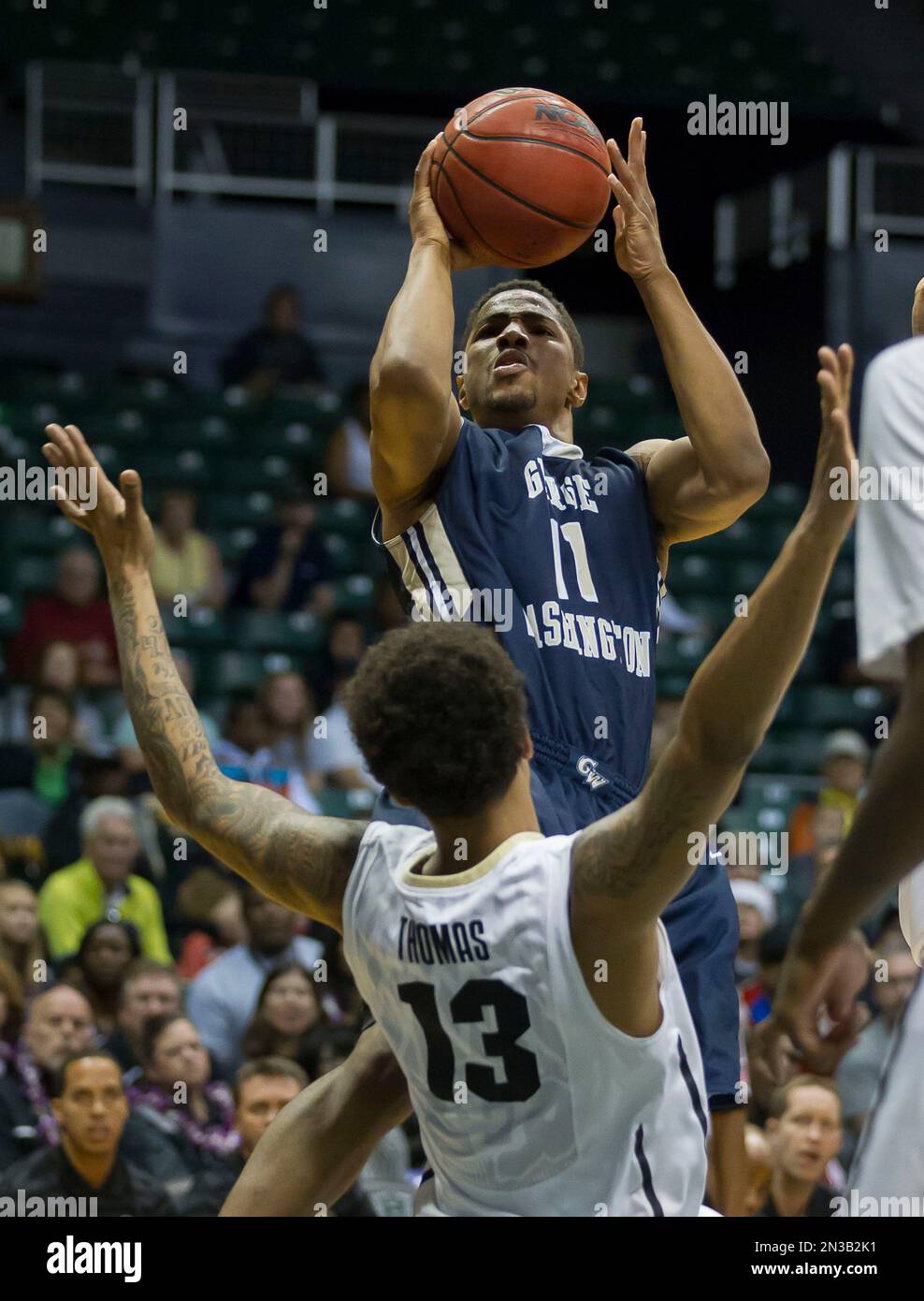 George Washington guard Kethan Savage (11) attempts a shot but is ...