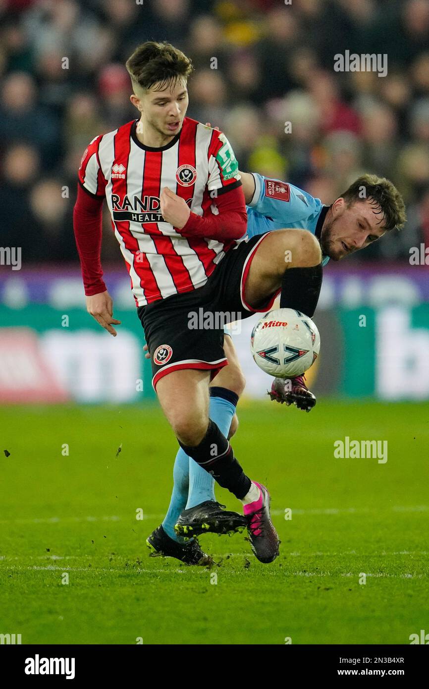 Sheffield's James McAtee is challenged by Wrexham's Luke Young, rear ...