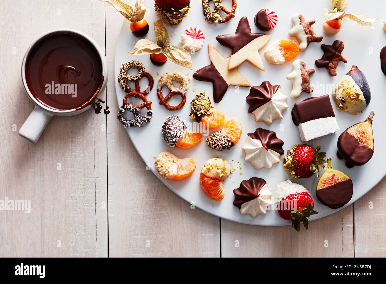 Cookies and sweets dipped in melted chocolate on a platter Stock Photo ...