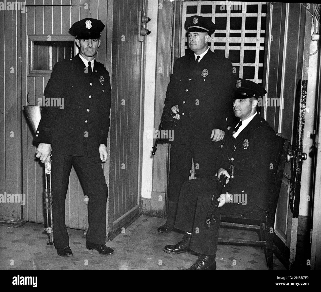 A special machine gun guard of three policemen is placed near the cell ...