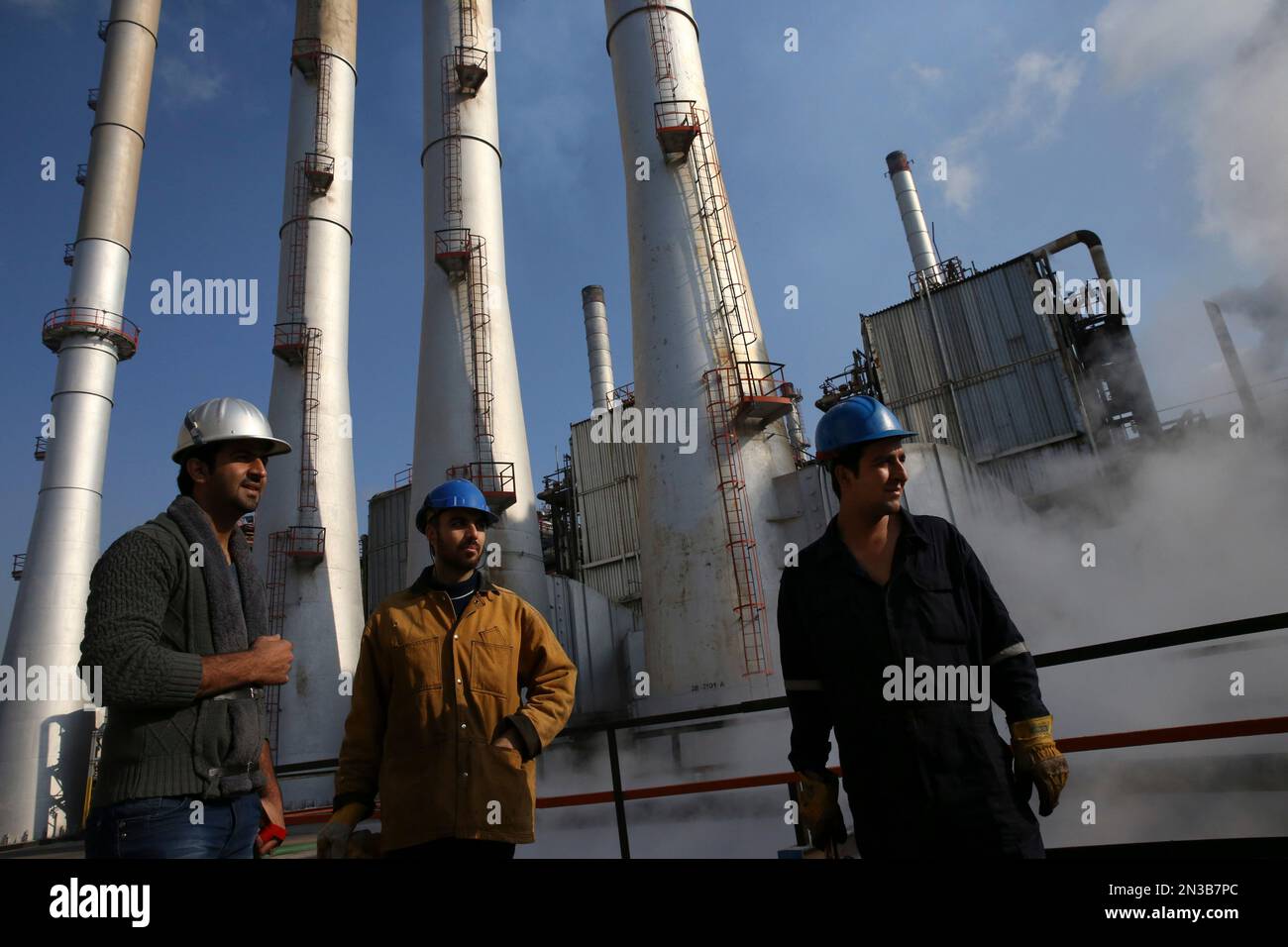 Iranian oil workers gather at the Tehran's oil refinery south of the ...