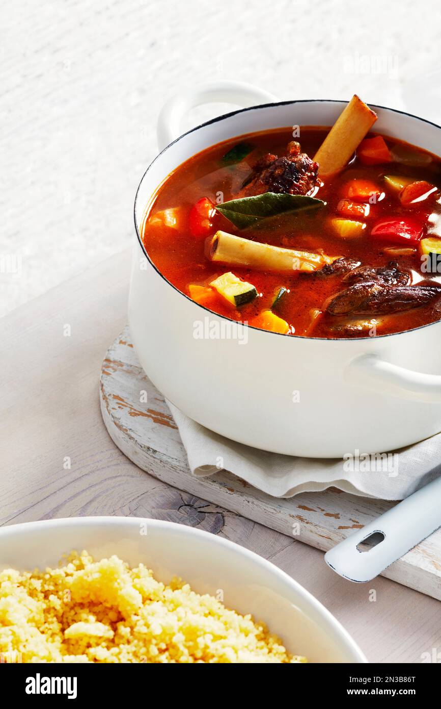 Moroccan lamb soup in pot with couscous sidedish Stock Photo - Alamy