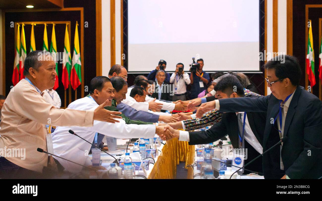 Representatives of Myanmar government peace making group, left, shake ...